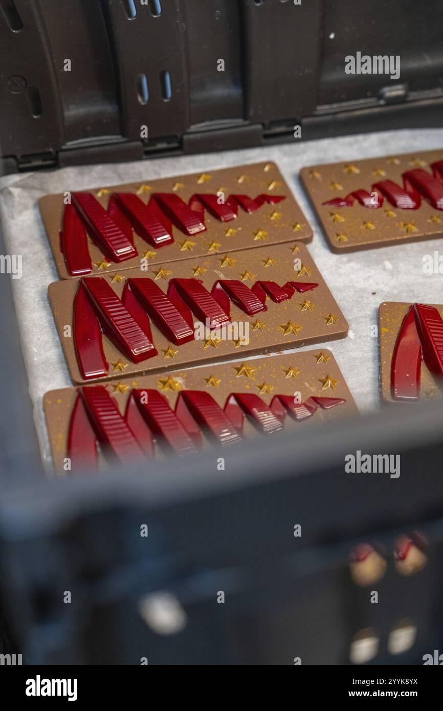 Chocolate bars with red patterns and golden stars in a box, Christmas ...