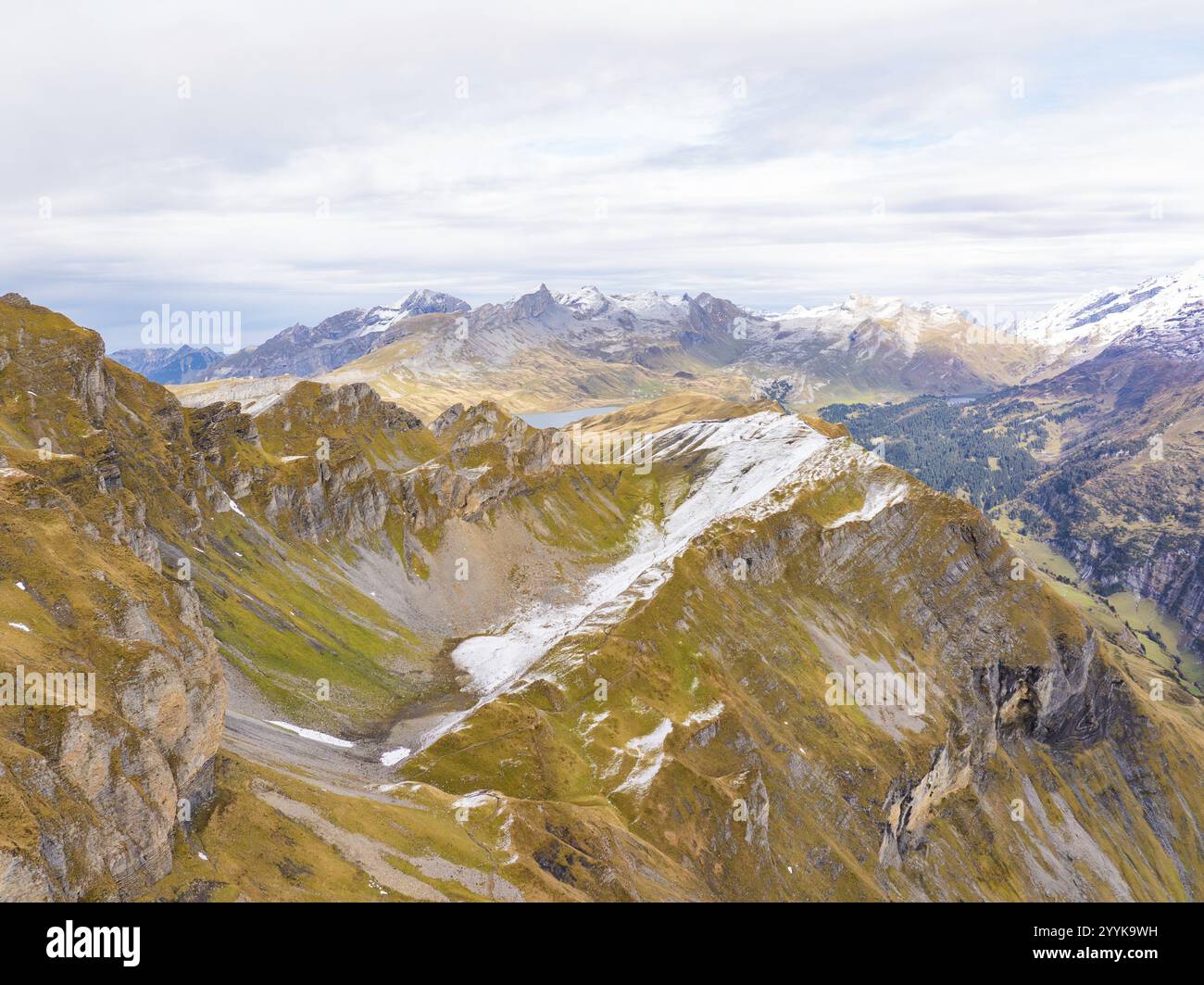 Dramatic view of a rocky mountain landscape with snowfields and valleys ...