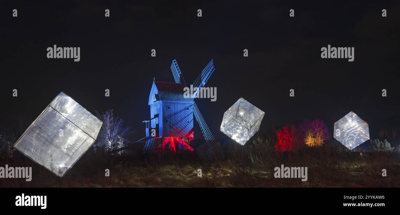 Windmill with illuminated cubes in a darkly lit scene at night, World ...