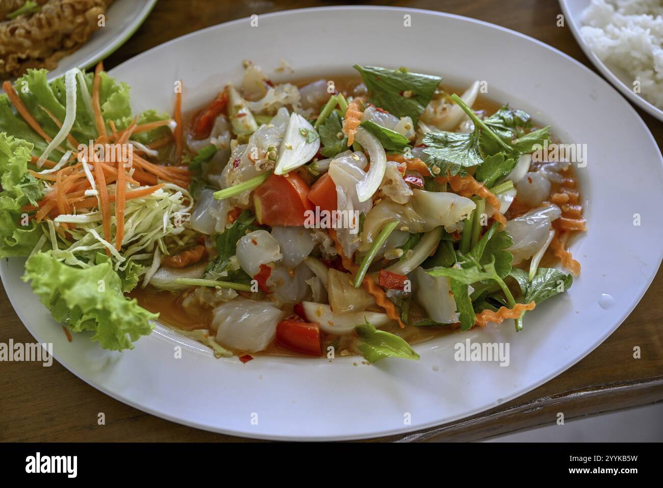 Spicy jellyfish salad with celery, onions, chilli, lime and fresh coriander leaves in a street ...