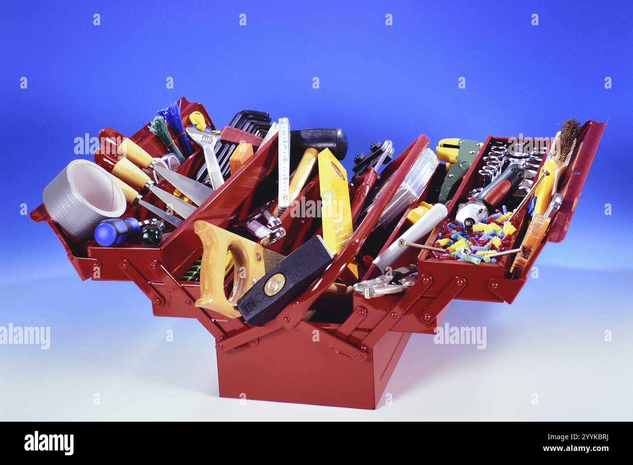 A red toolbox with tools, hammer, screwdriver, adhesive tape, folding ...