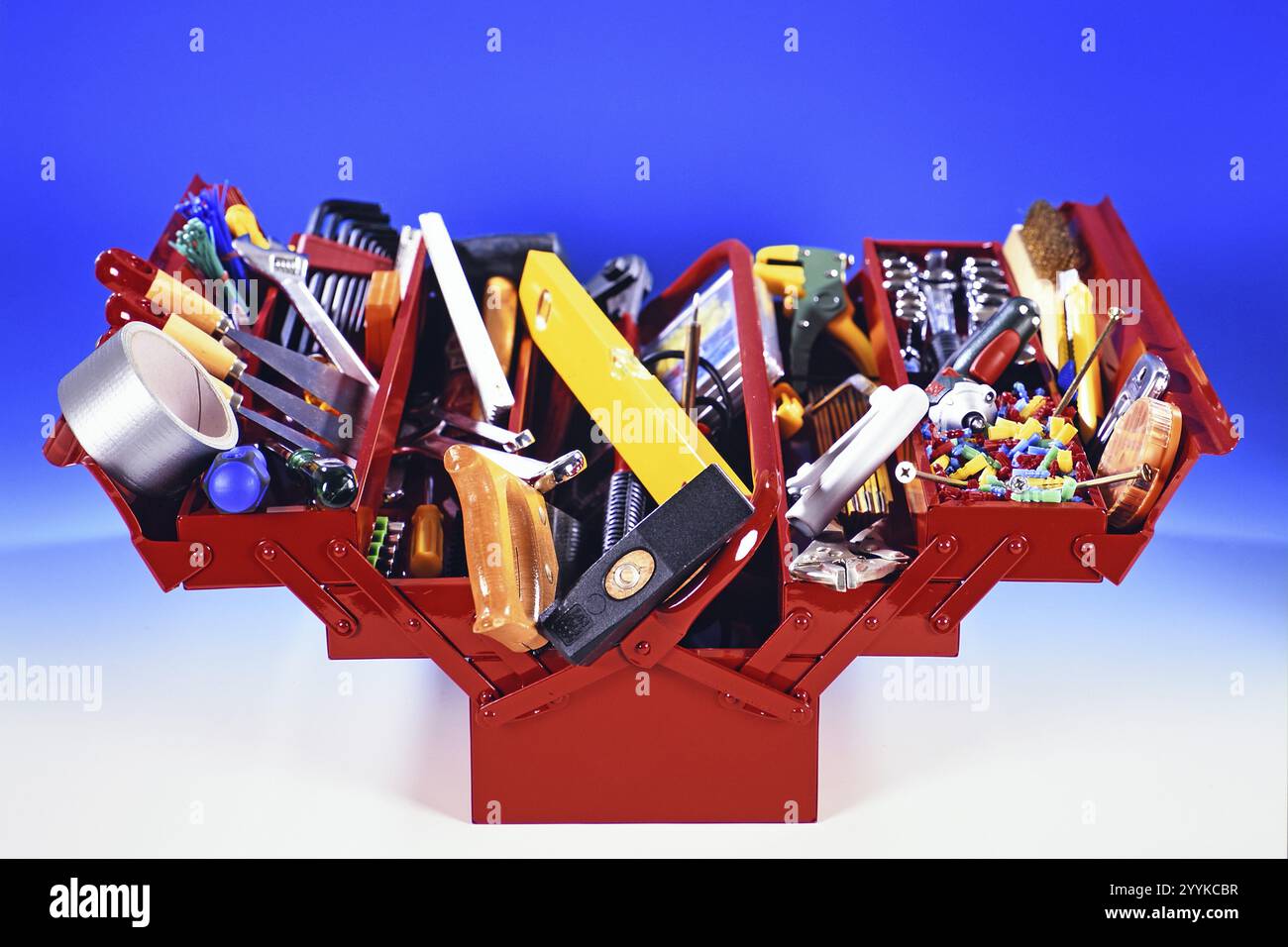 A red toolbox with tools, hammer, screwdriver, adhesive tape, folding ...