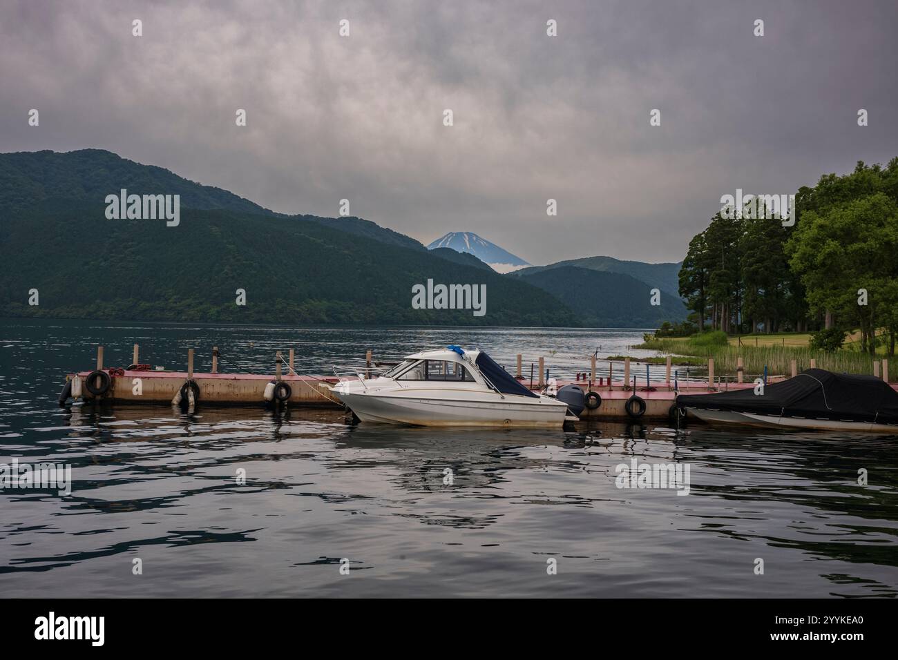 Boats anchored on a dock on Lake Ashinoko near Hakone, Japan, during an ...