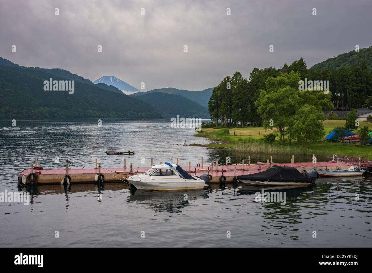 Boats anchored on a dock on Lake Ashinoko near Hakone, Japan, during an ...