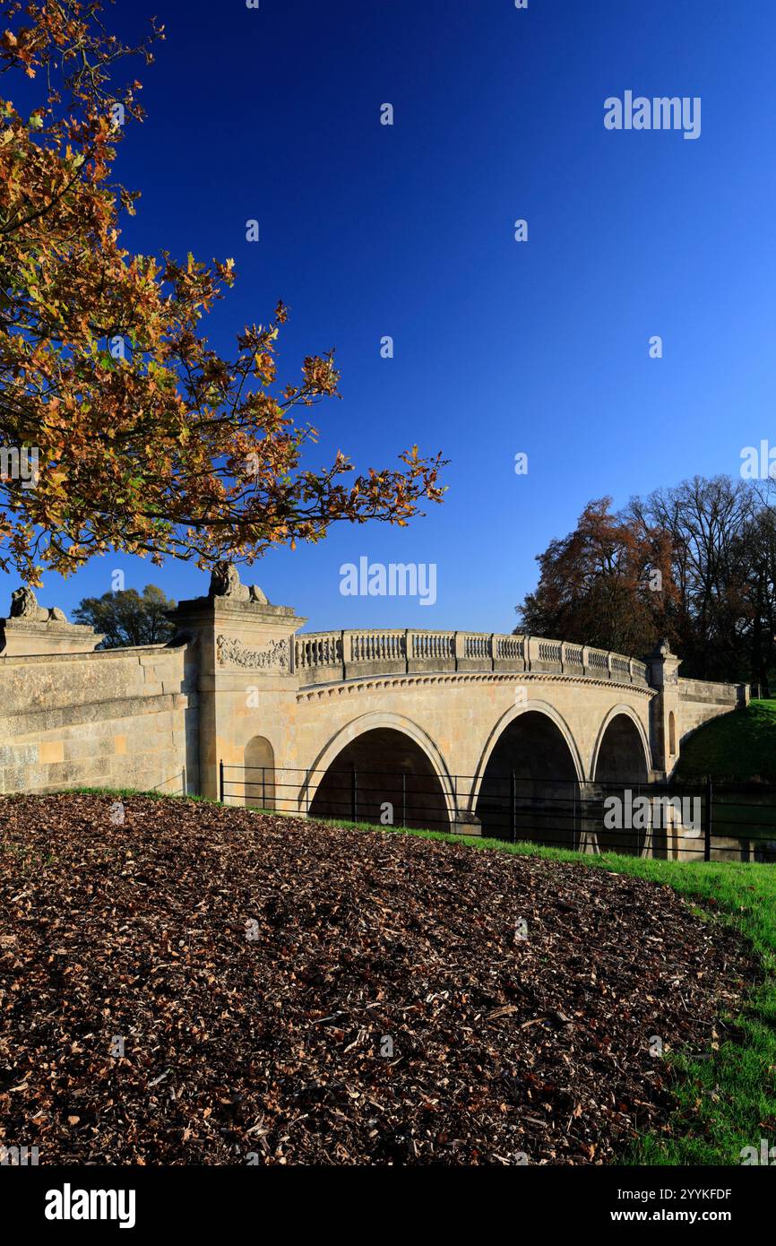 Autumn colours looking at the Lion Bridge of Burghley house, an ...