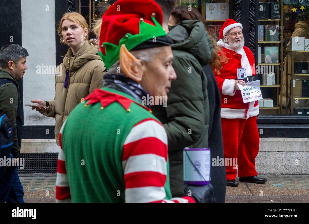 © Jeff Moore Santa and one of his elf cheering up Christmas shoppers on ...