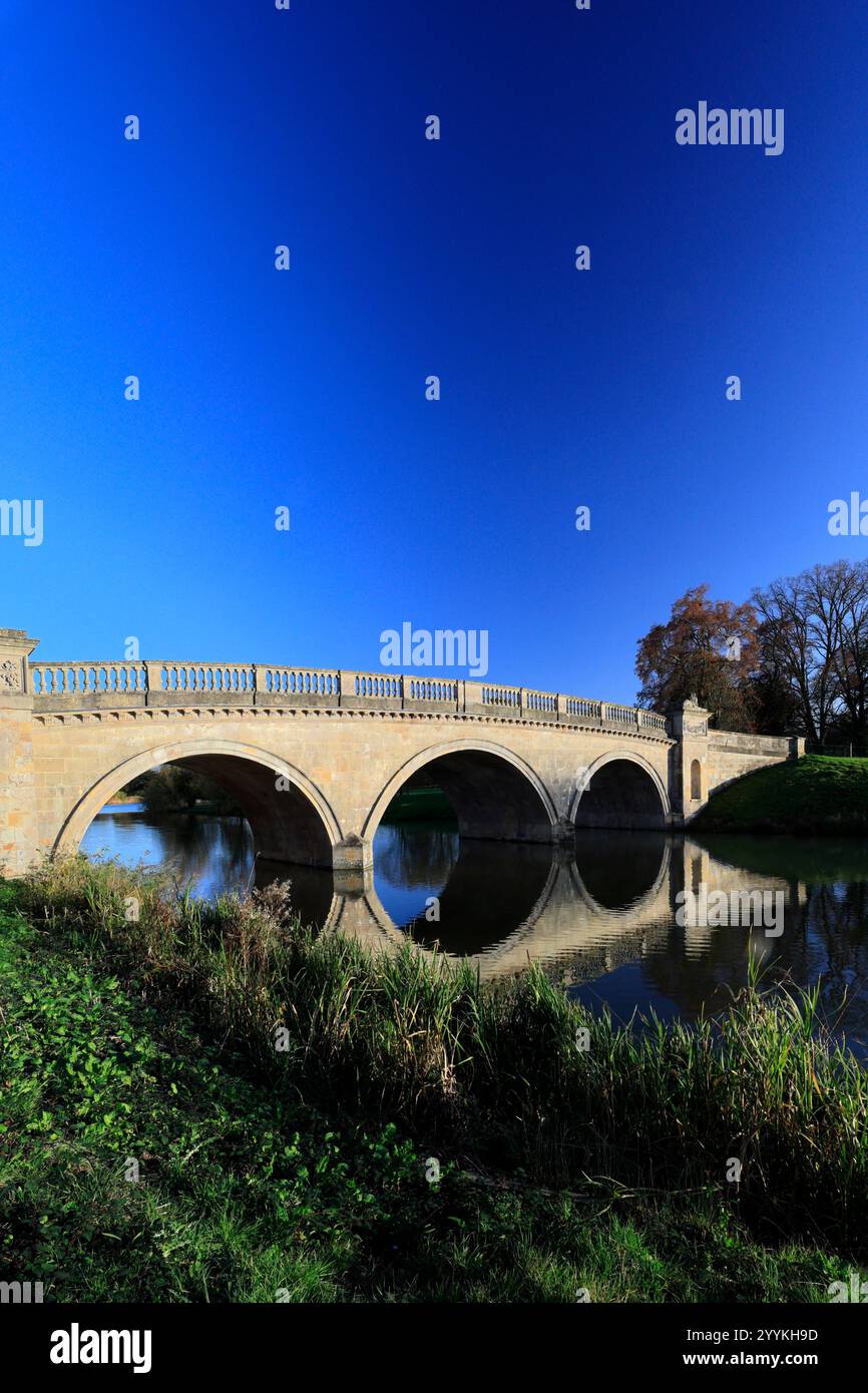 Autumn colours looking at the Lion Bridge of Burghley house, an ...