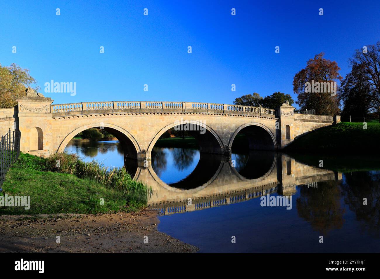 Autumn colours looking at the Lion Bridge of Burghley house, an ...
