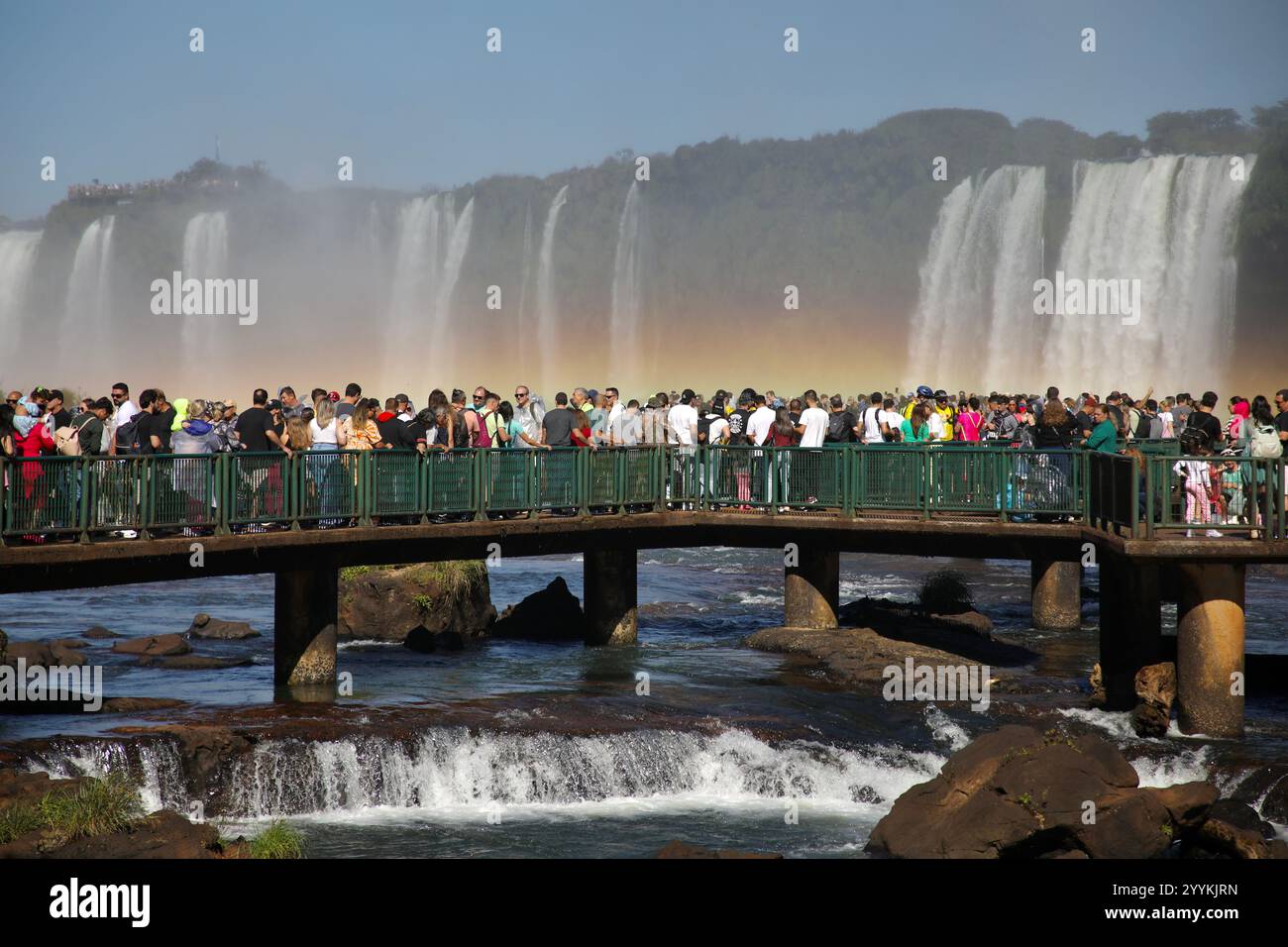 Tourists seen looking at the Devil's Throat fall crowd on a footbridge ...