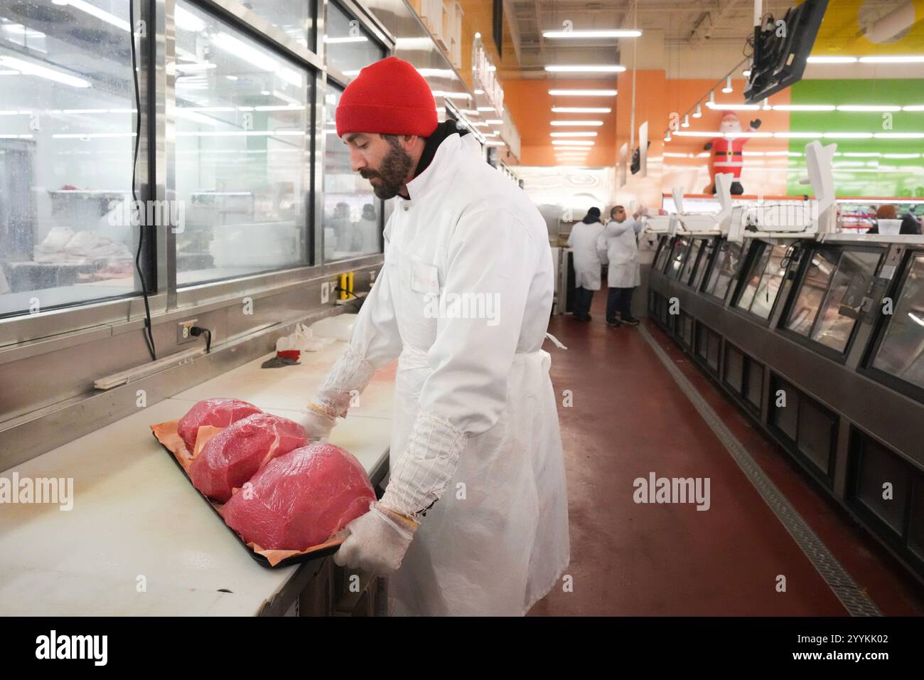 Beef is put out onto the display counter at an Adonis grocery store in ...
