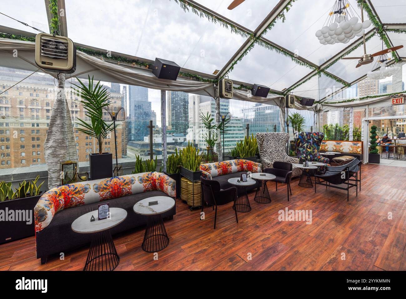 Modern rooftop lounge with panoramic city views, stylish seating, lush ...