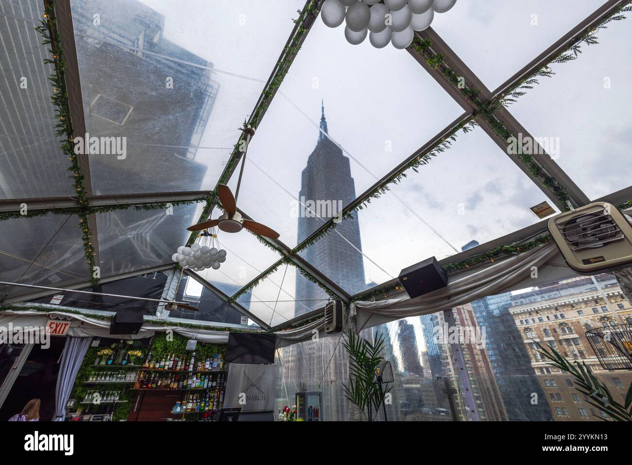 View of Empire State Building through transparent glass rooftop of ...