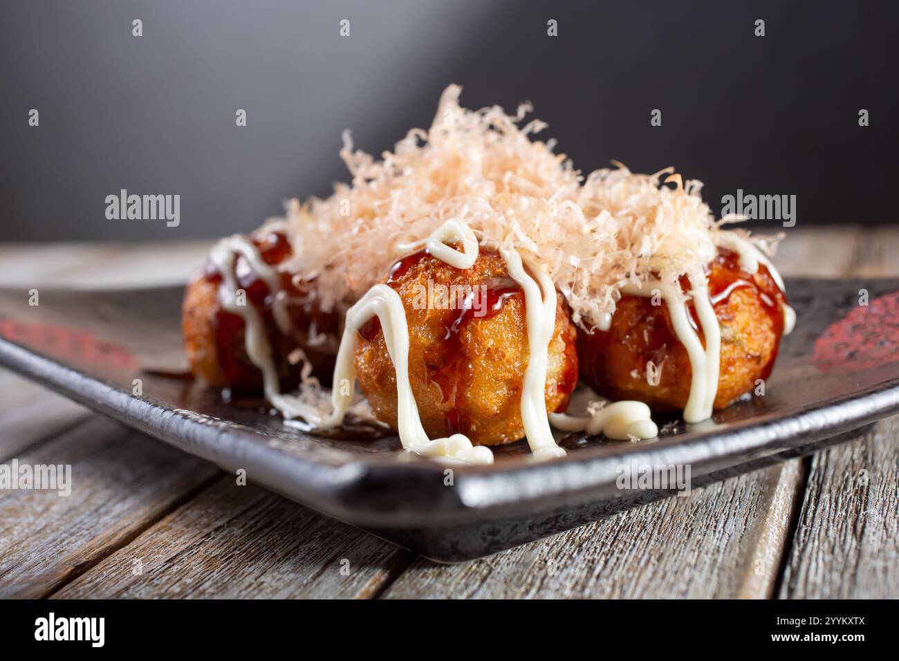 A view of a plate of takoyaki, which is Japanese deep fried octopus ...