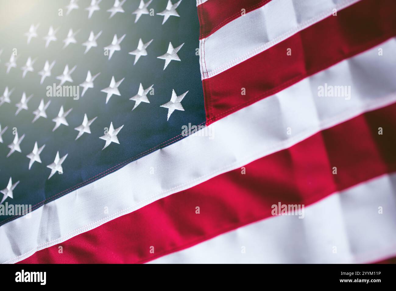 An angled view the United States of America flag, with a light flare ...