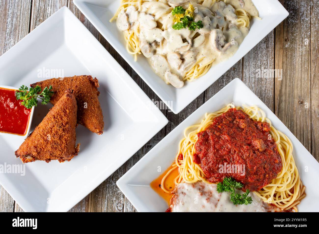 A top down view of several Italian entrees, featuring deep fried ...