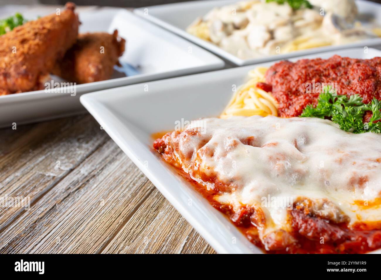 A view of several Italian entrees, featuring chicken parmigiana Stock ...
