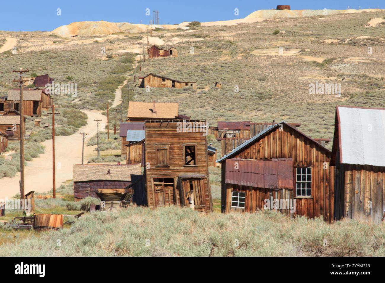 A small town with old buildings and a dirt road. The buildings are old ...