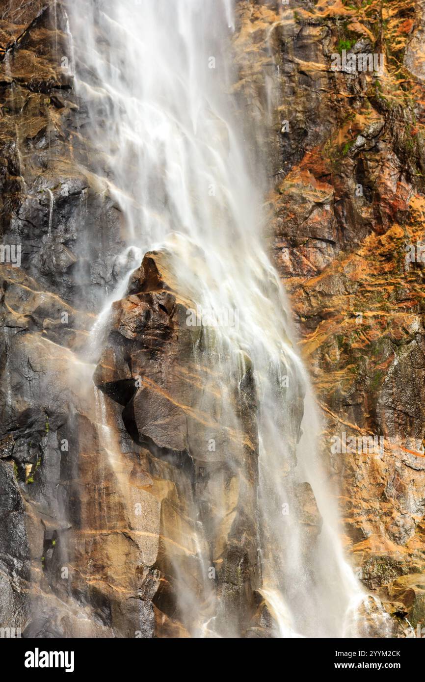 A waterfall is shown in the image, with the water flowing down the side ...