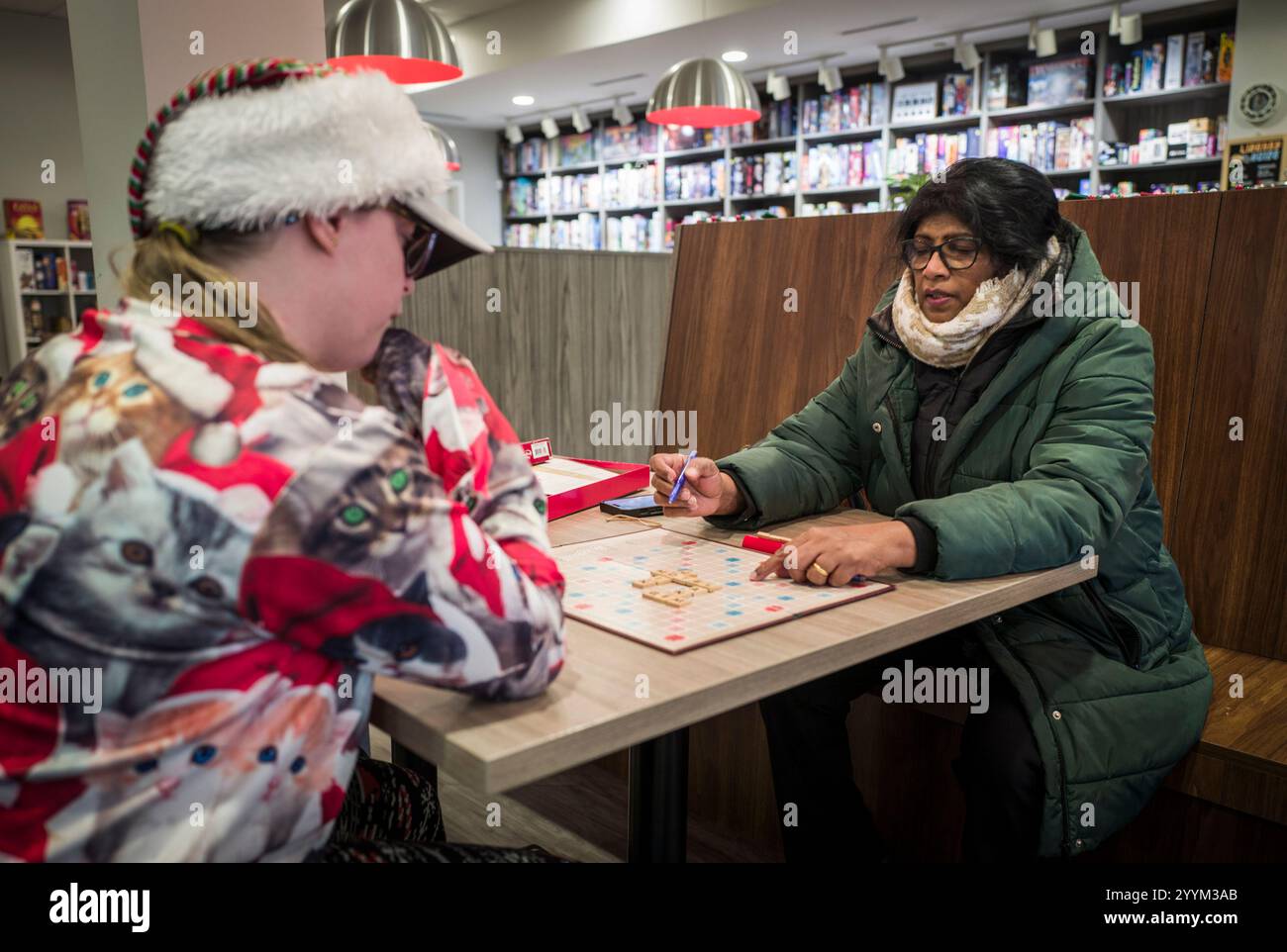 Calgary, Canada. 19th Dec, 2024. Patrons play Scrabble at the D6 ...