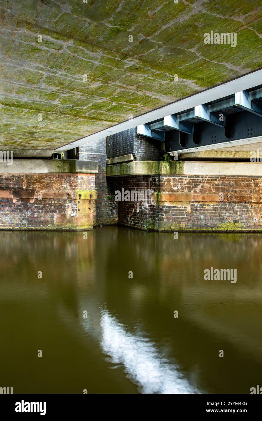 View under railway bridge over canal UK Stock Photo - Alamy