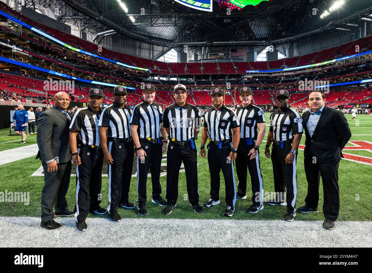 Officials pose for a photo before an NFL football game between the ...