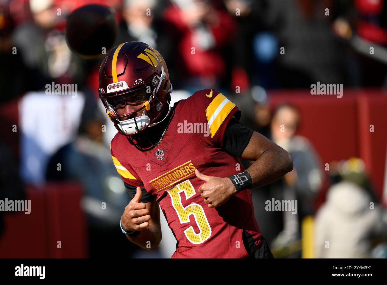 Washington Commanders quarterback Jayden Daniels (5) running onto the ...
