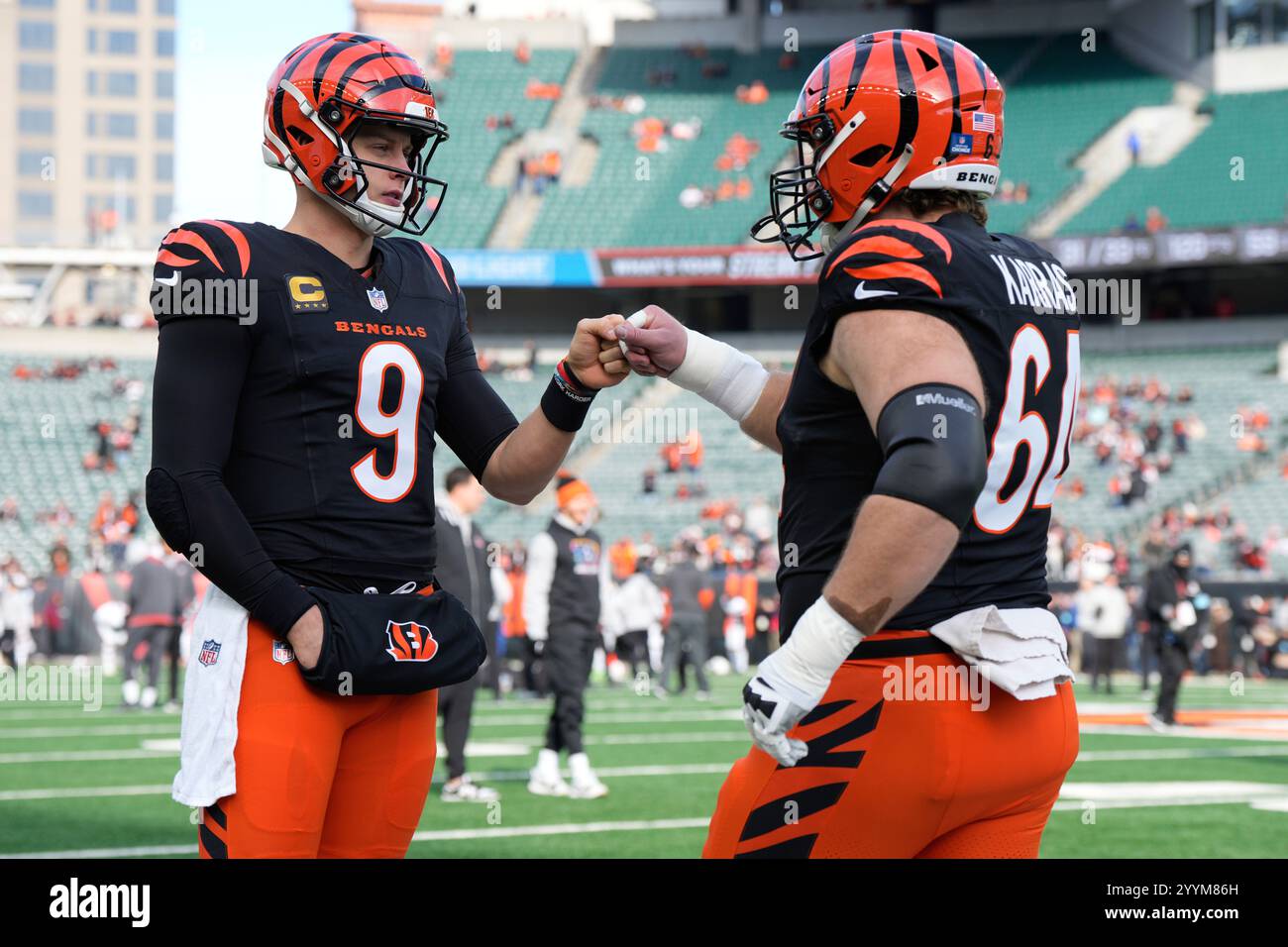 Cincinnati Bengals quarterback Joe Burrow (9) fist bumps center Ted ...