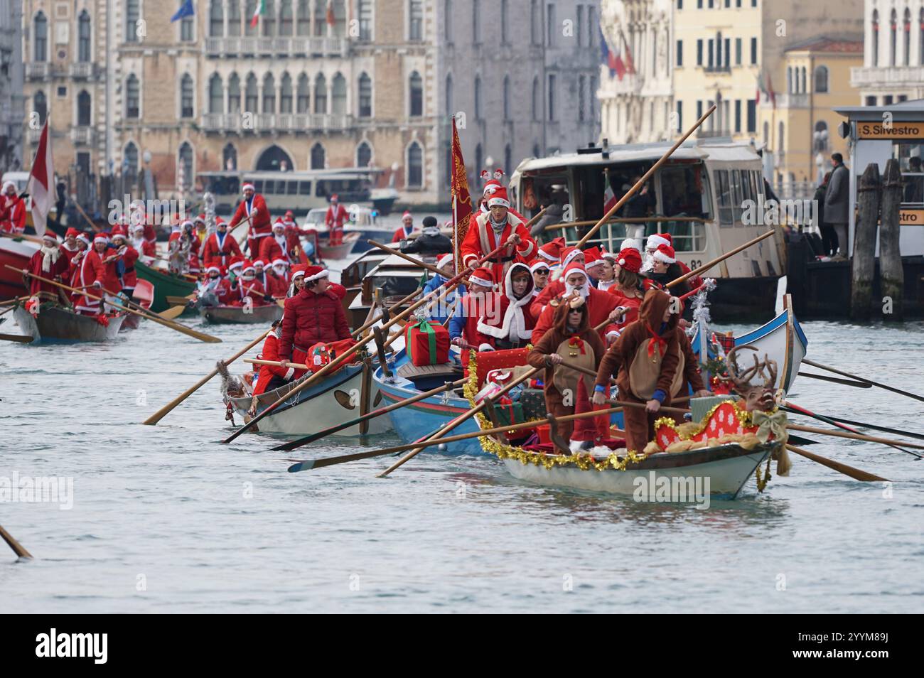 People wearing Santa Claus costumes drive Gondolas on Canal Grande (The ...