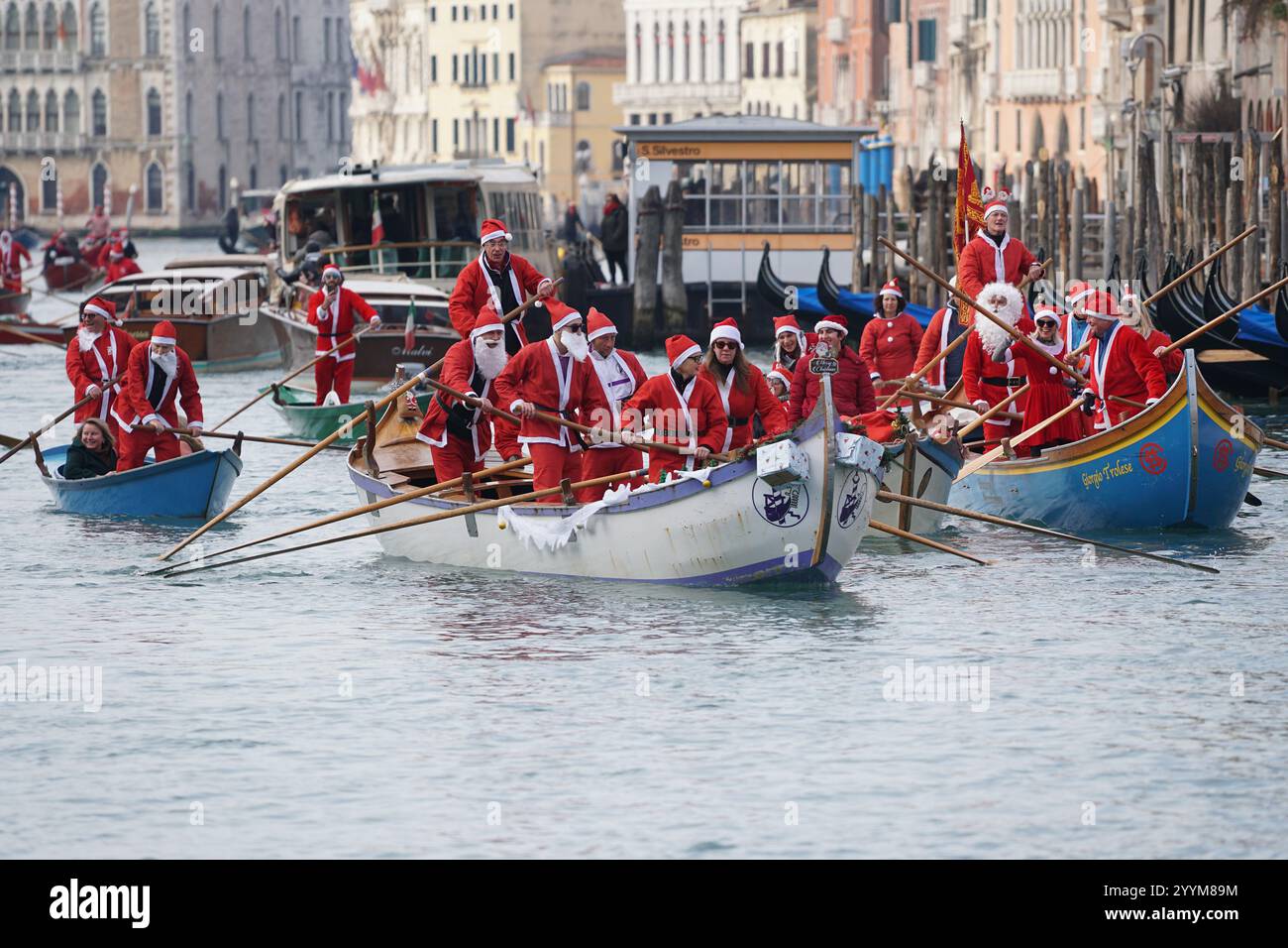 People wearing Santa Claus costumes drive Gondolas on Canal Grande (The ...