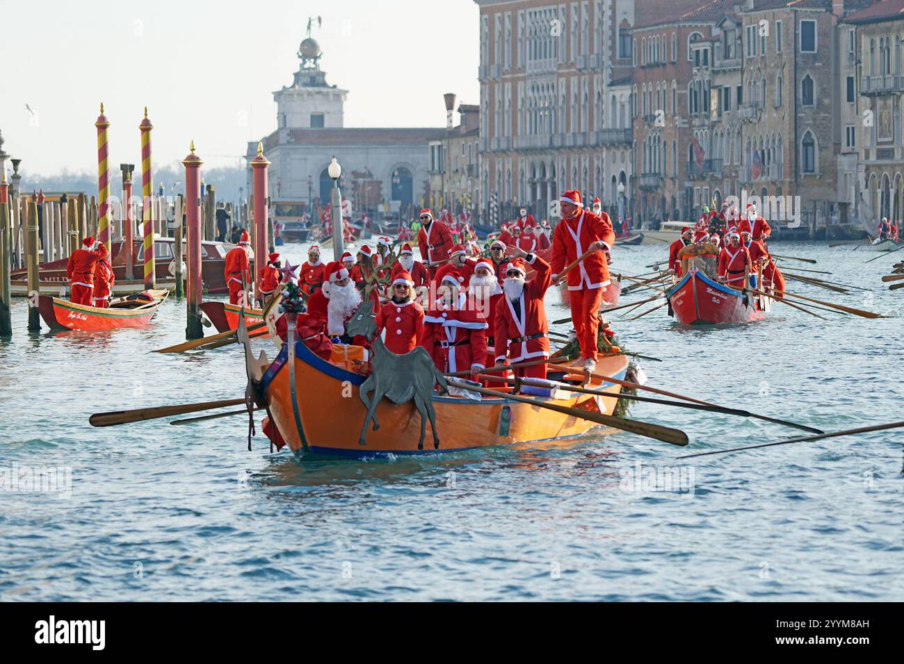 People wearing Santa Claus costumes drive Gondolas on Canal Grande (The ...