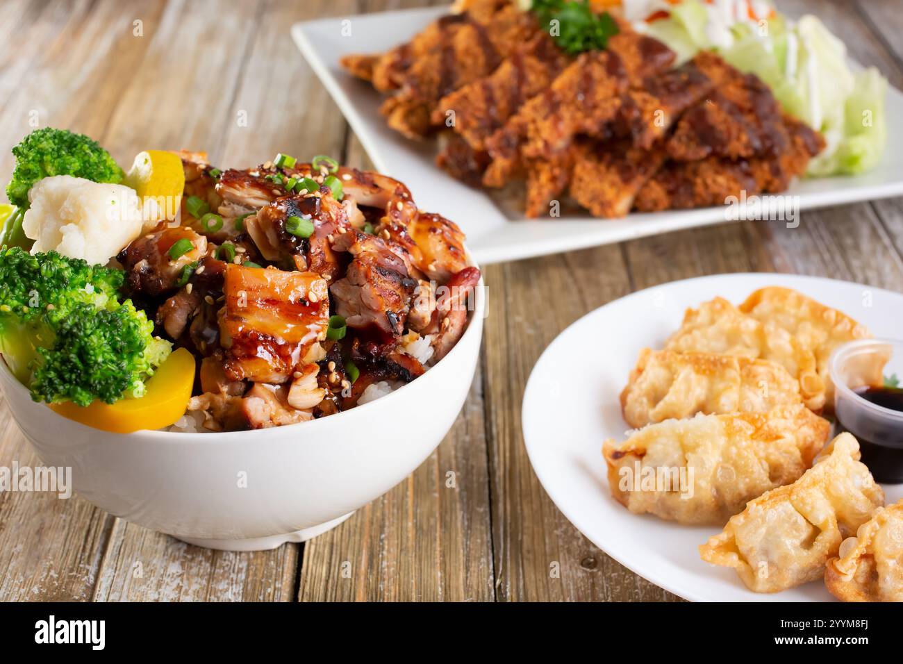 A view of several pan asian entrees featuring a teriyaki chicken bowl ...