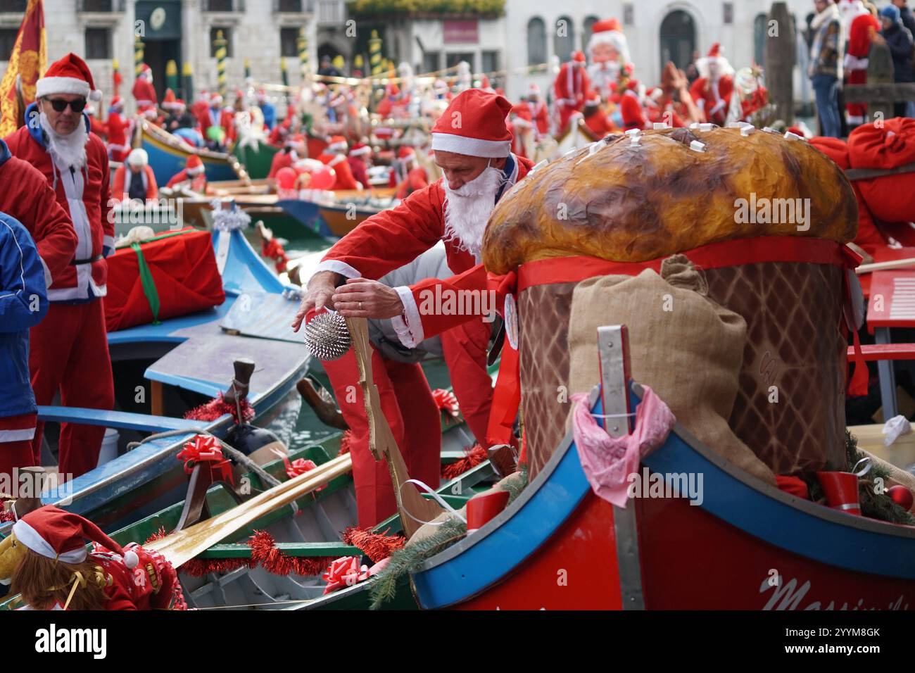 People wearing Santa Claus costumes drive Gondolas on Canal Grande (The ...