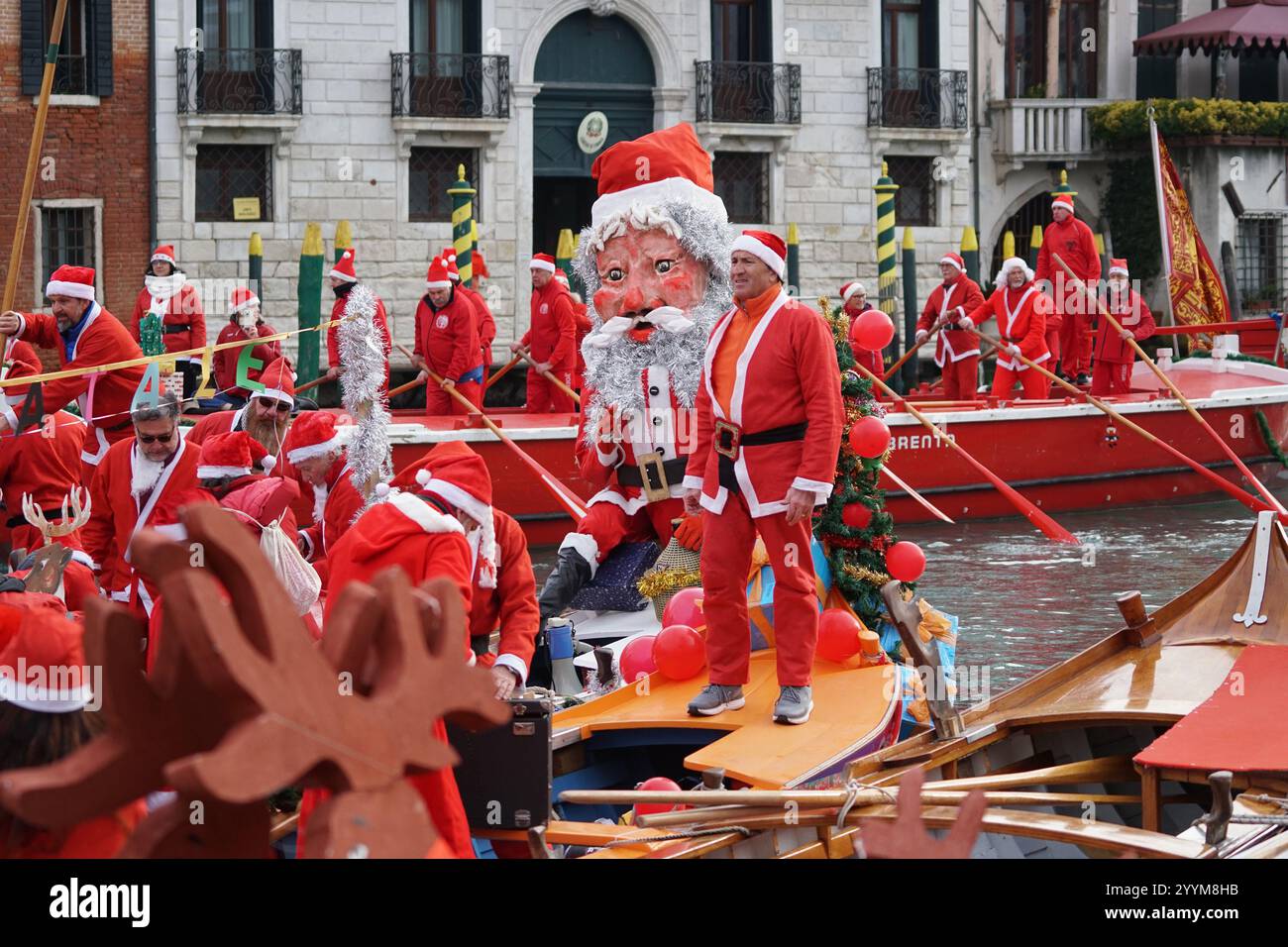 People wearing Santa Claus costumes drive Gondolas on Canal Grande (The ...