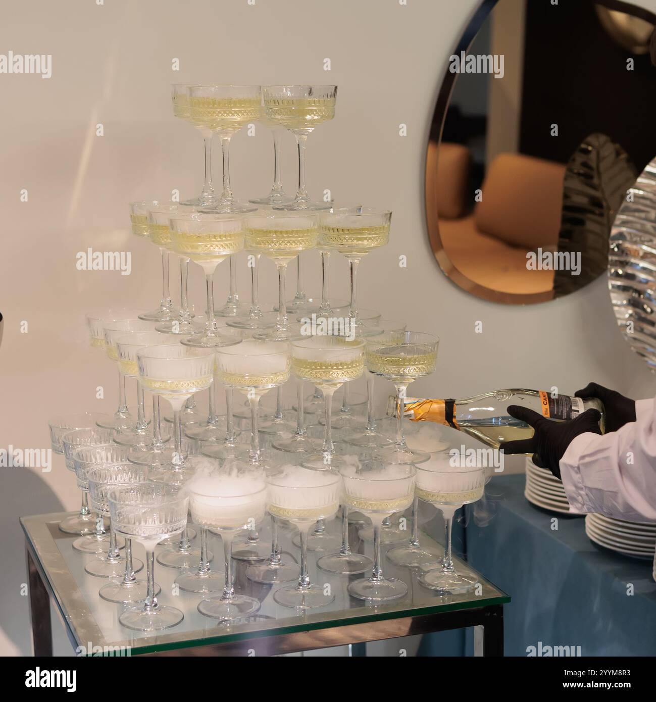 Towering pyramid of champagne glasses filled with bubbly, elegantly ...