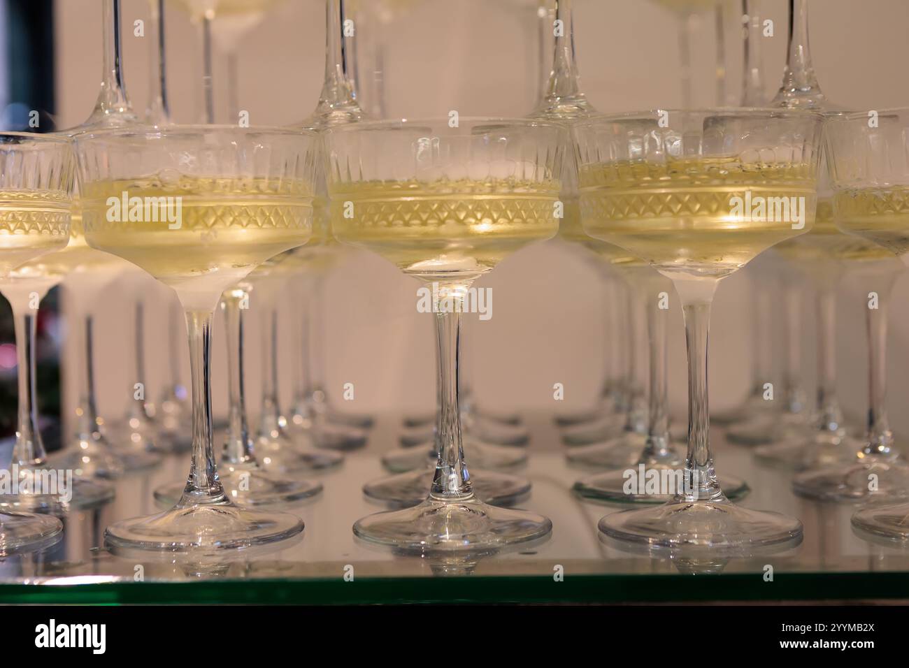 Towering pyramid of champagne glasses filled with bubbly, elegantly ...