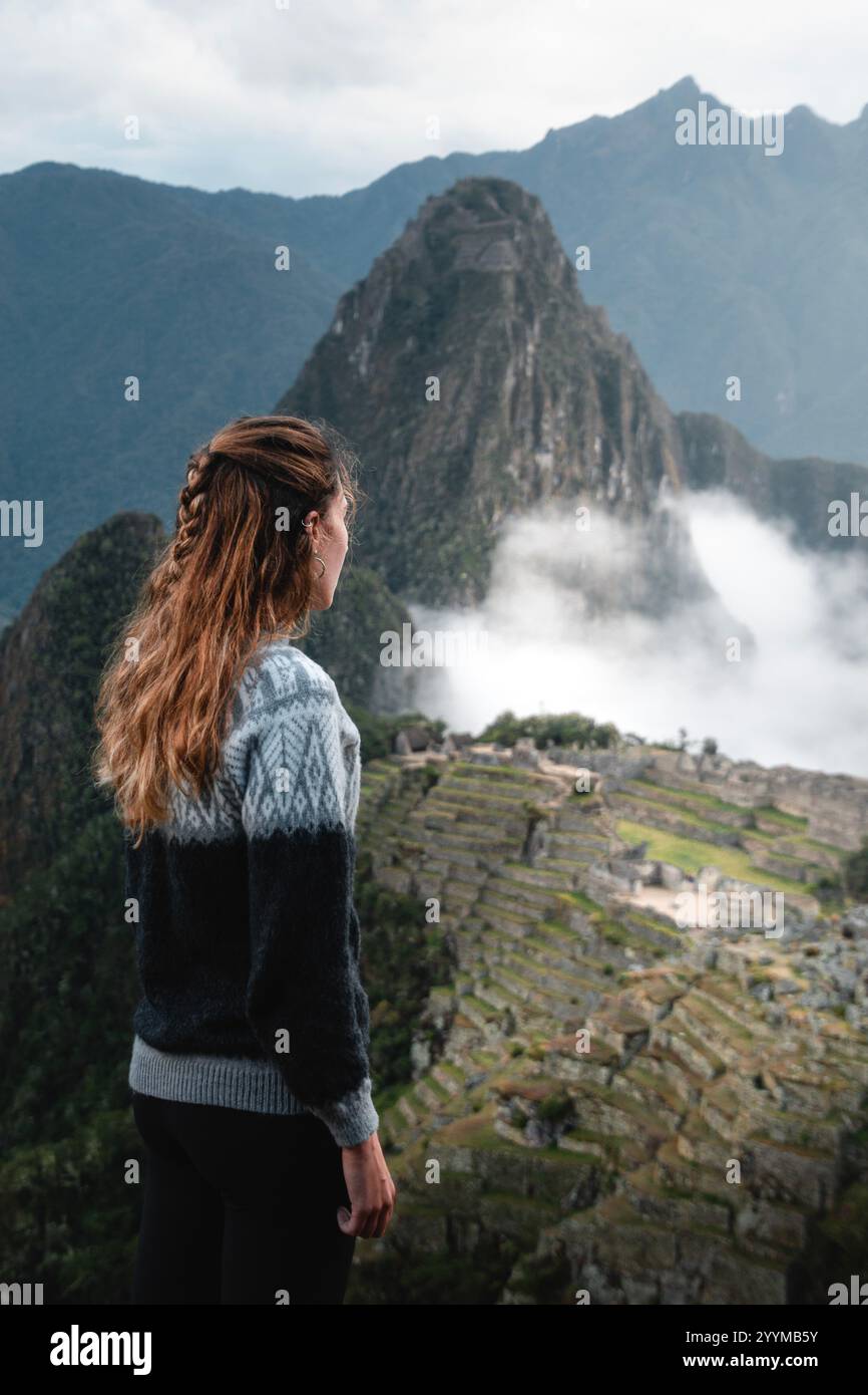 Young Woman hairstyle with braid Admiring Machu Picchu in Peru Stock ...
