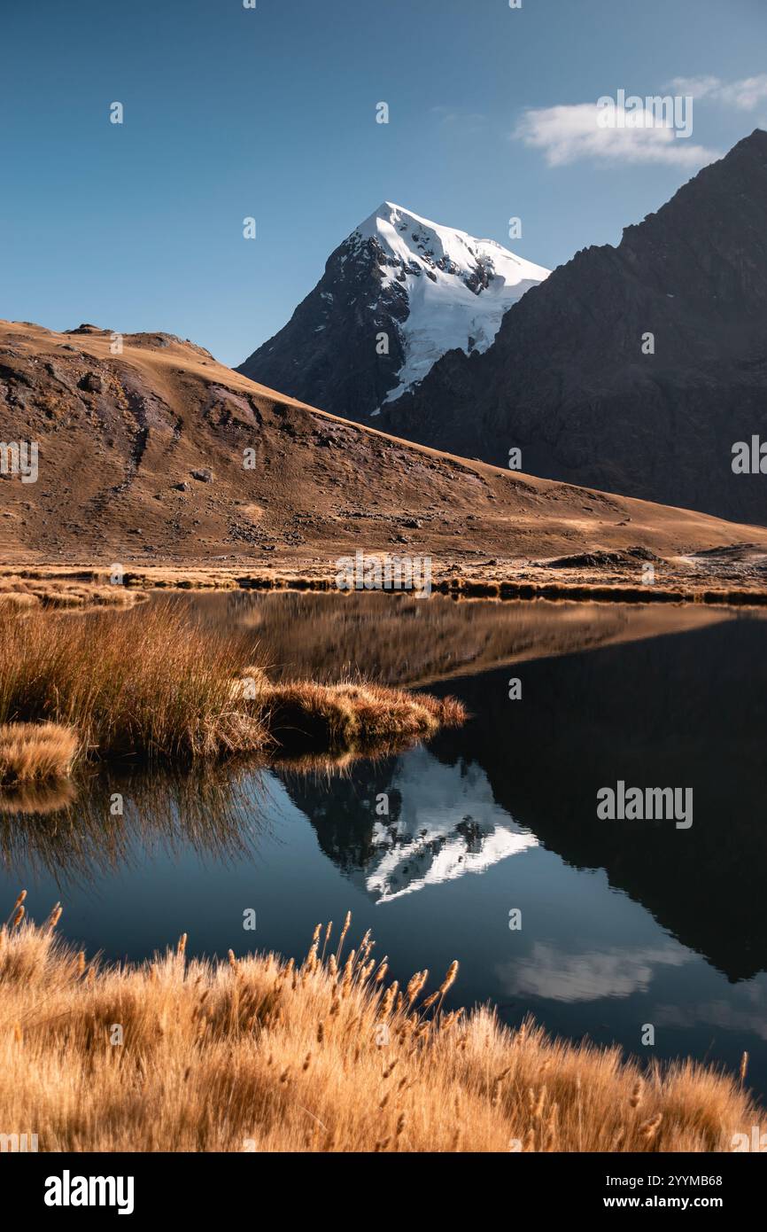 Stunning view of a snowy peak reflecting in a tranquil lake amidst the ...