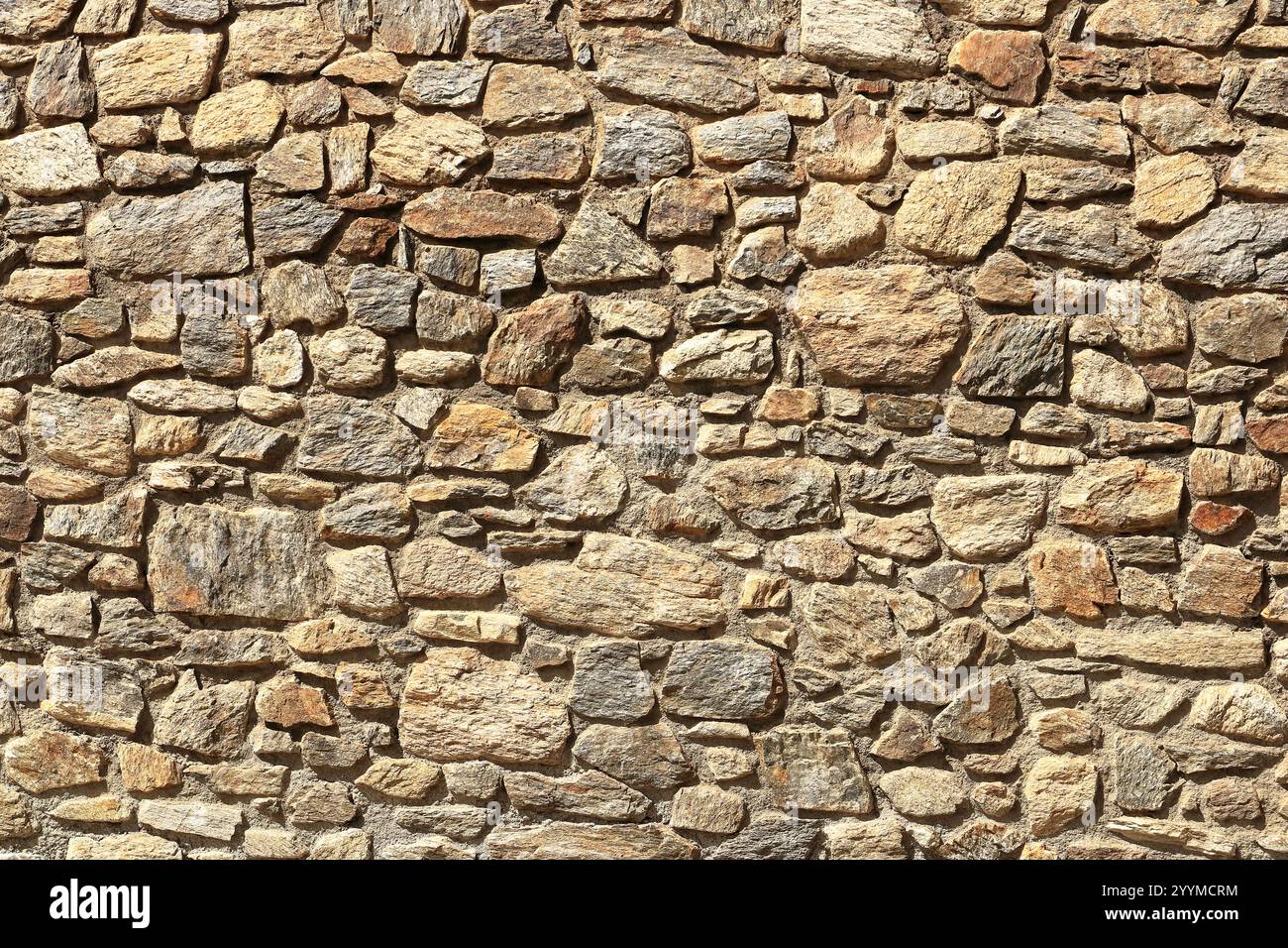 a yellow beige sand color stone brick vertical wall Stock Photo - Alamy