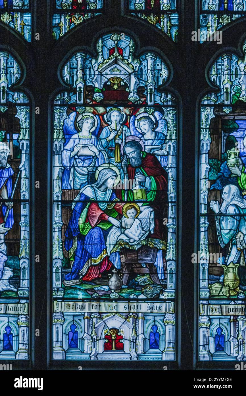 A stained glass window depicting the Holy Family. The image is full of ...