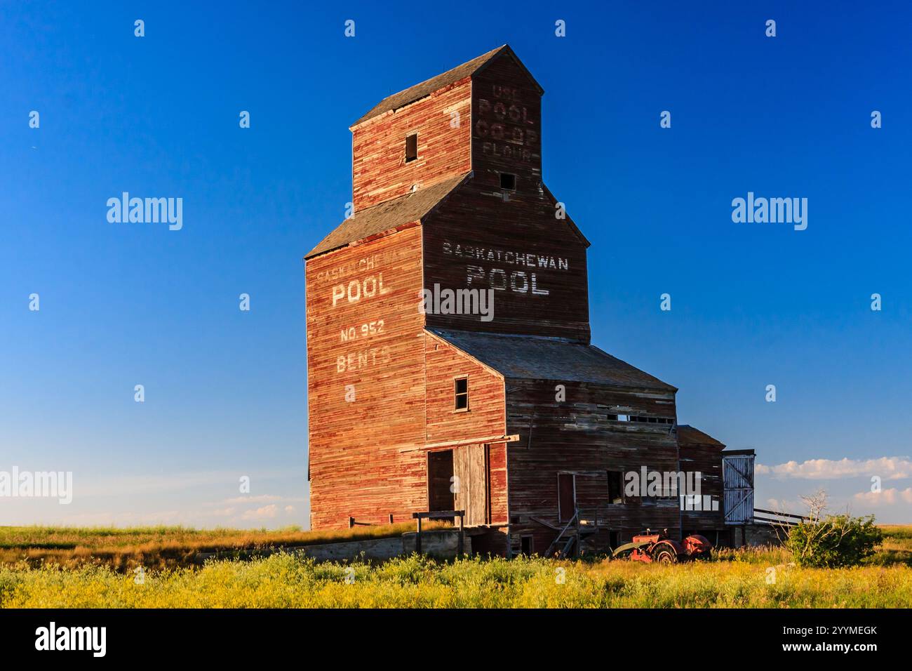 A red grain silo with a pool written on it. The silo is old and ...