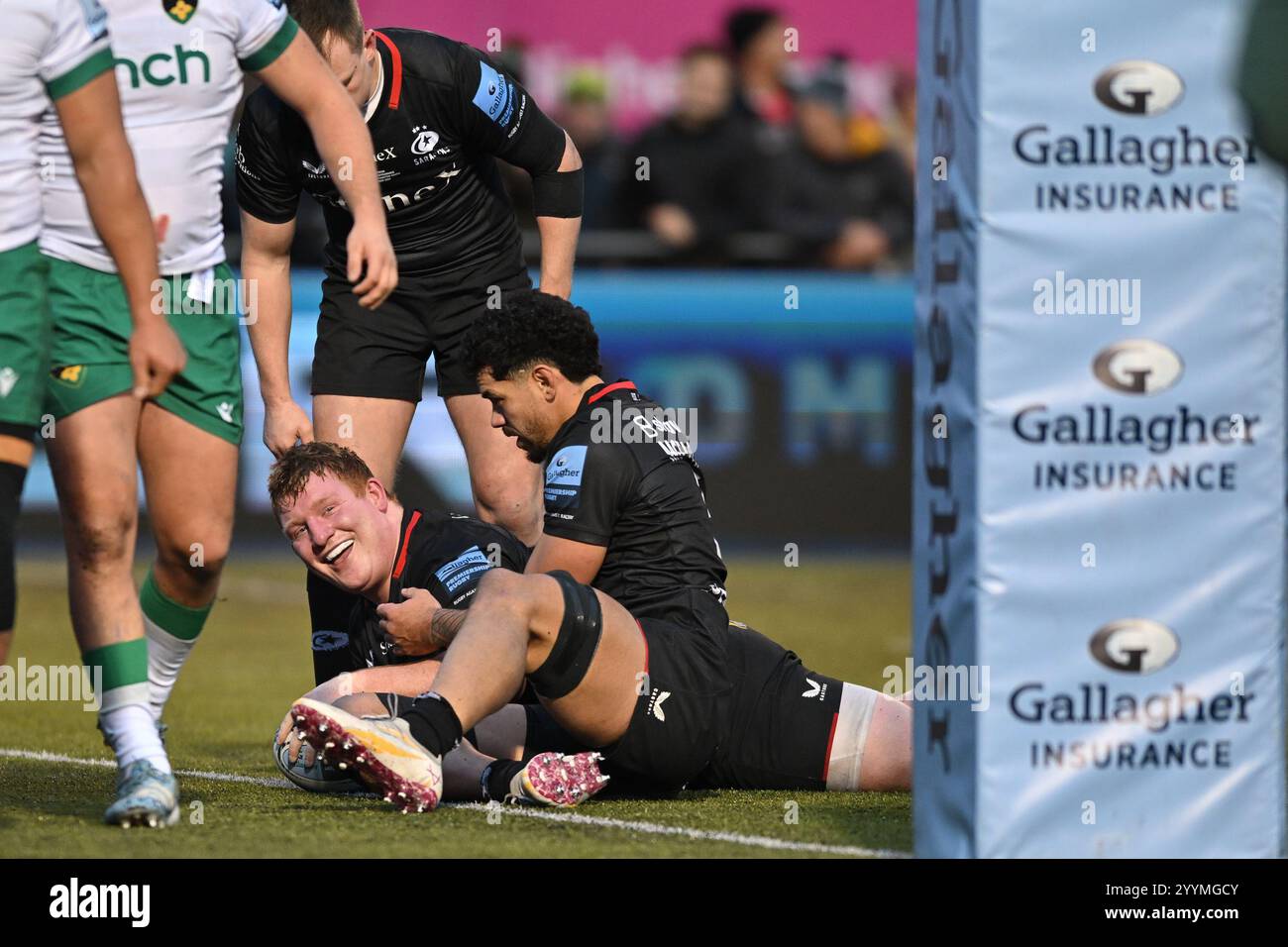 Rhys Carre of Saracens goes over the line to score in the first half ...