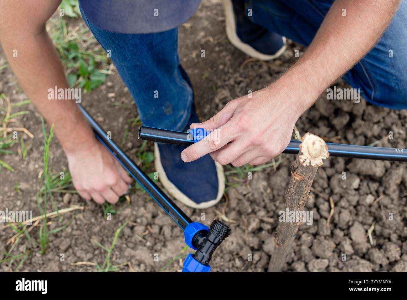Fixing and connecting pipes using a fitting. man installs an automatic ...