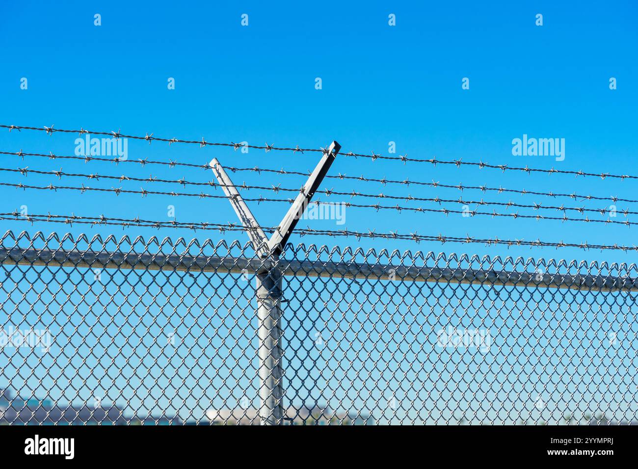Chan link fence with barbed wire on a Y shape support Stock Photo - Alamy
