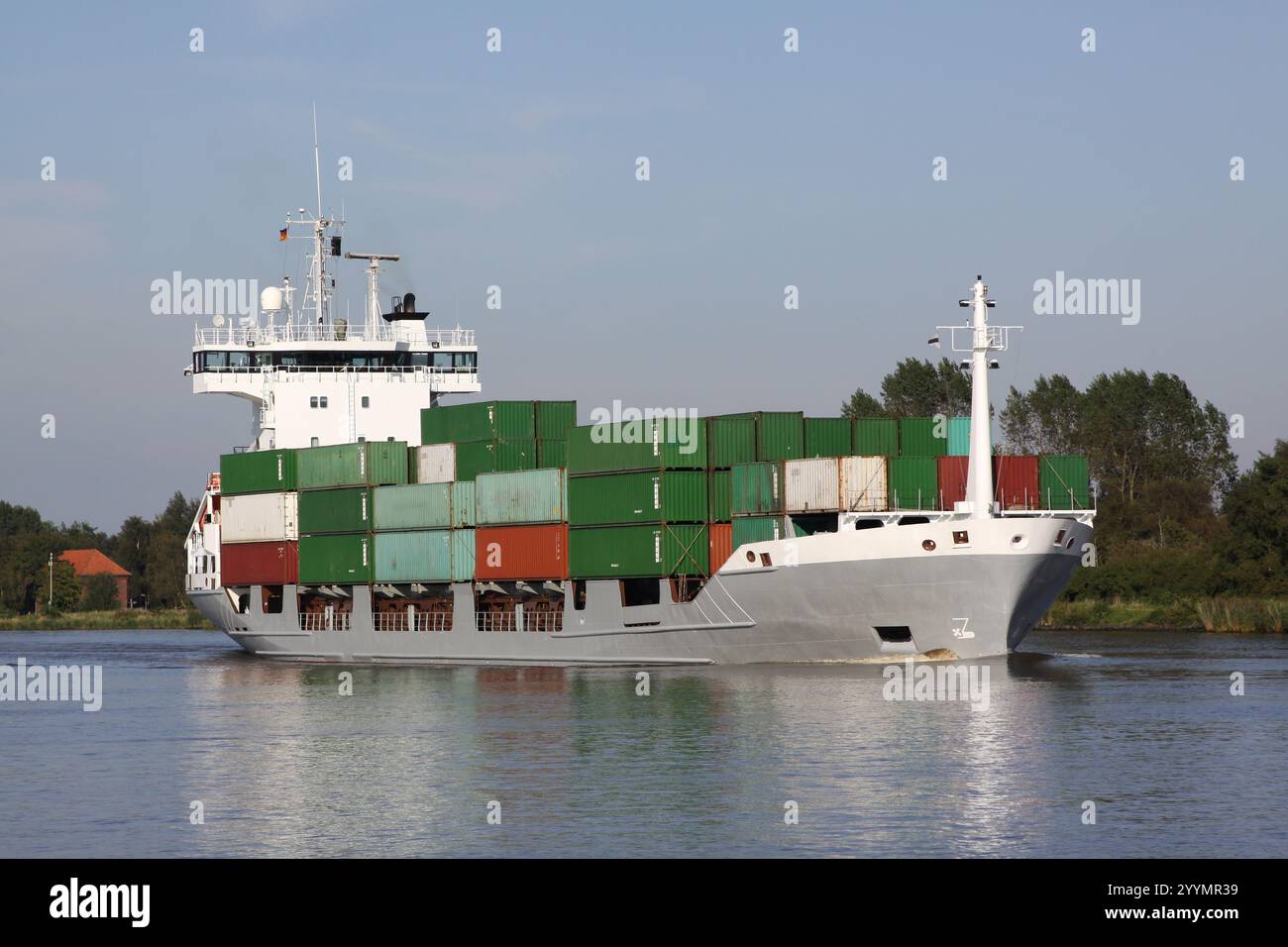 Grey colored Feeder Vessel with Green Containers, Navigating through ...
