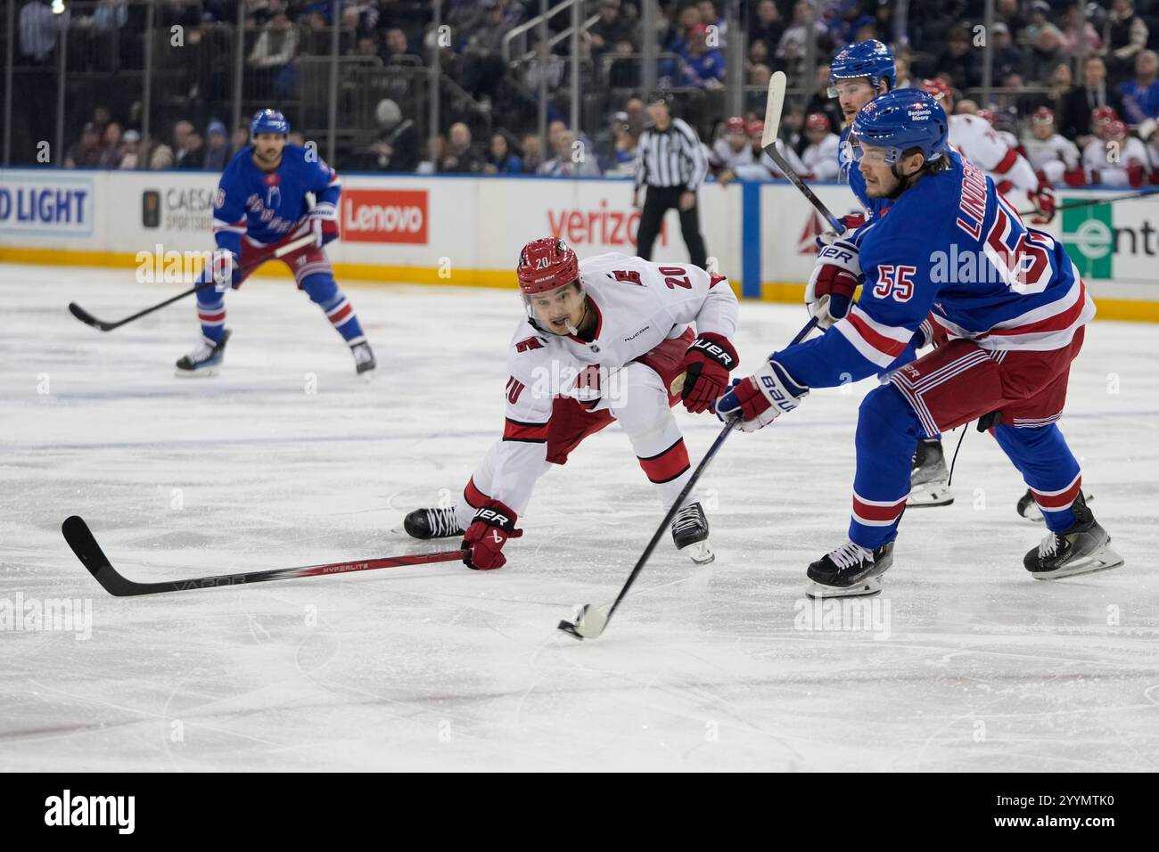 Carolina Hurricanes' Sebastian Aho (20) fights for control of the puck ...