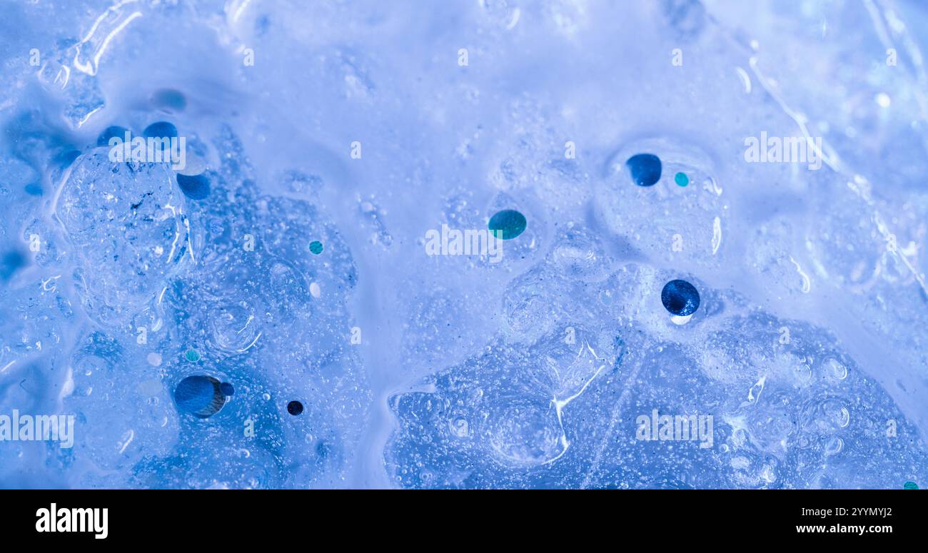 Frozen surface. Water glitter. Cold liquid with decorative sparks flows ...