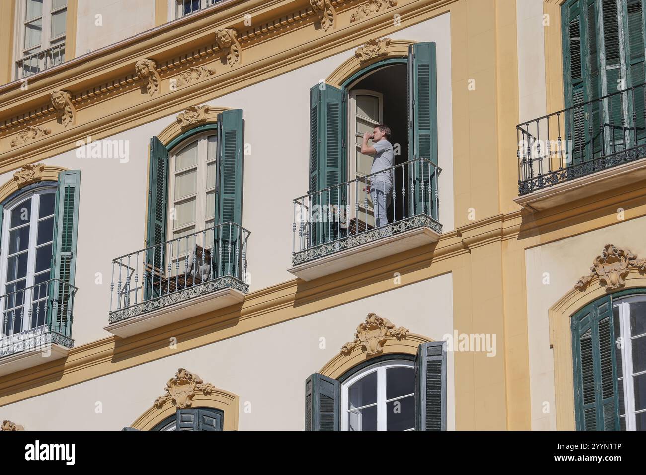 Person standing on balcony flats hi-res stock photography and images ...