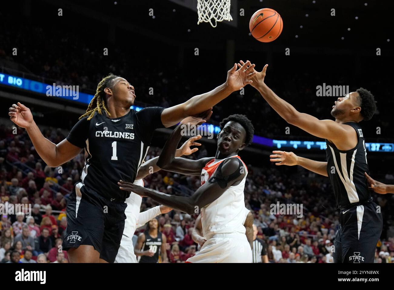 Morgan State forward Matar Wade, center, fights for a rebound with Iowa ...