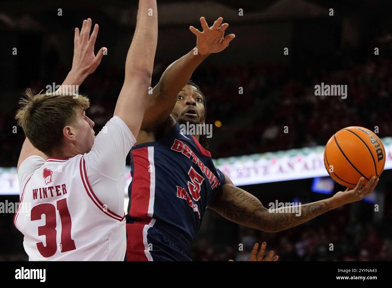 Detroit Mercy's Orlando Lovejoy tries to shoot past Wisconsin's Nolan ...