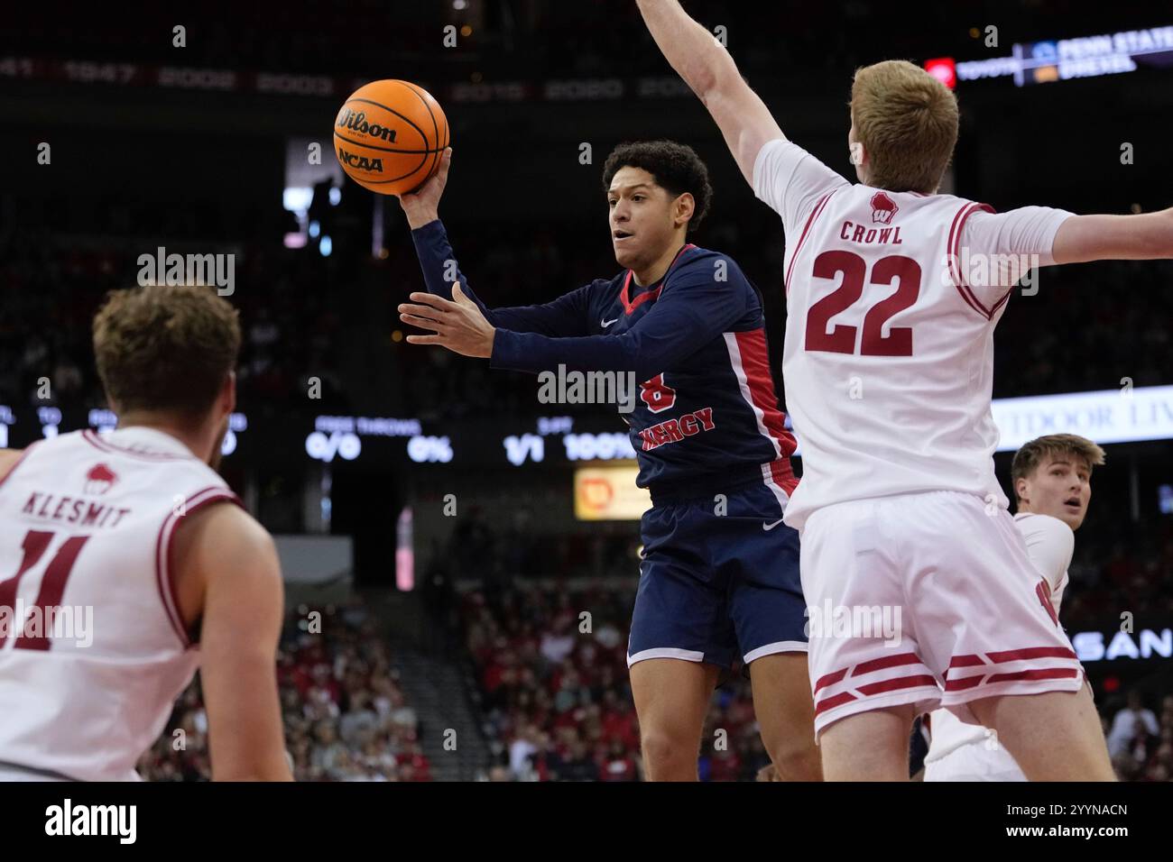 Detroit Mercy's Grant Gondrezick II passes around Wisconsin's Steven ...